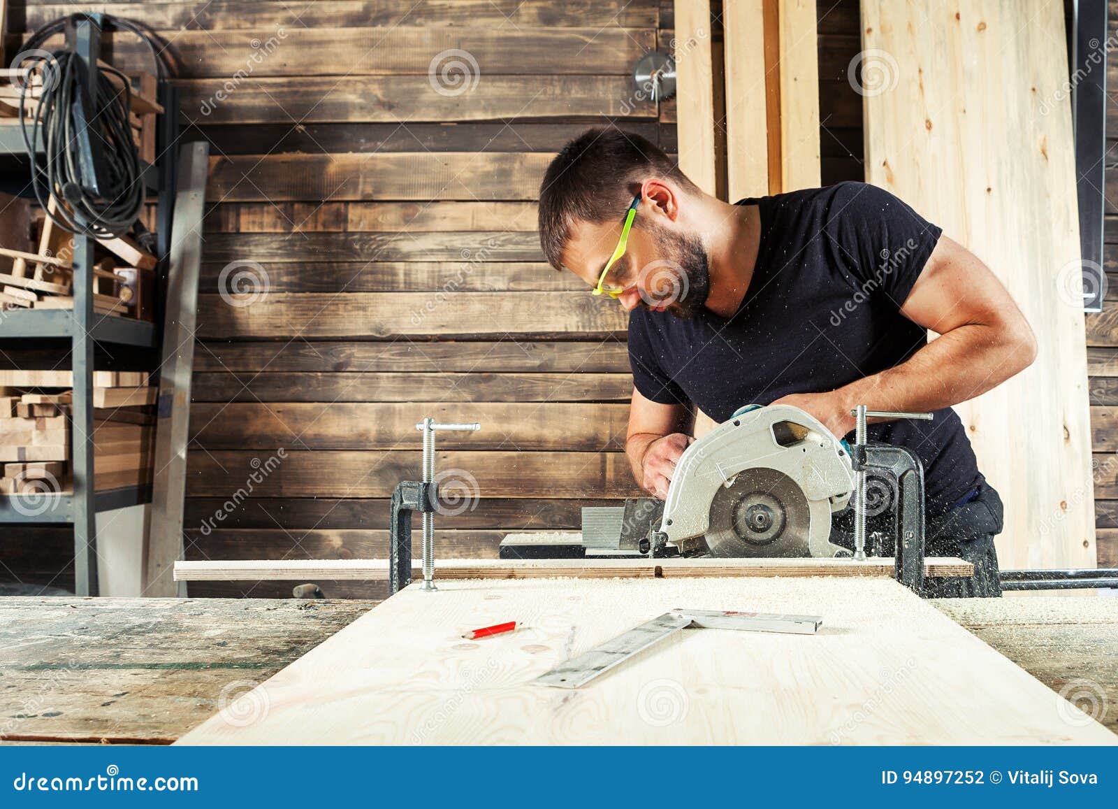 Builder saws a board stock photo. Image of occupation - 94897252