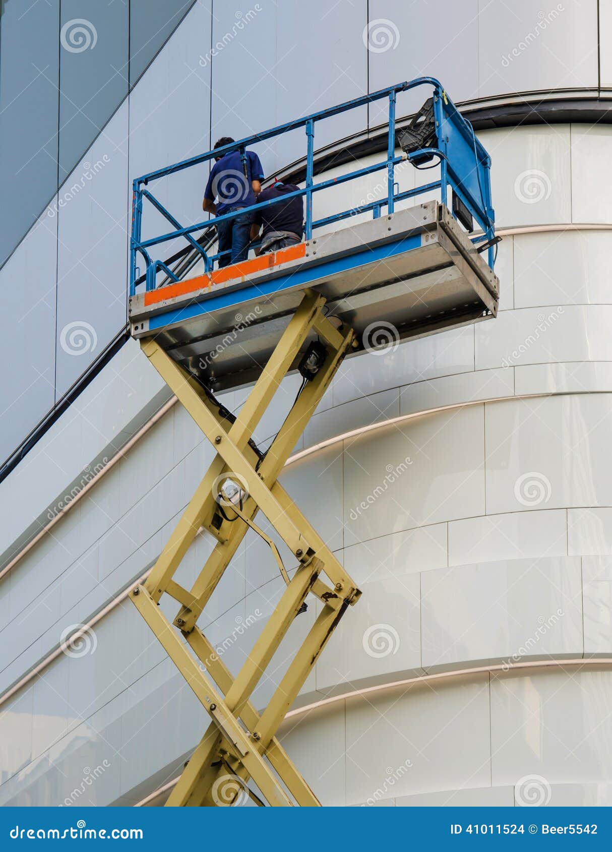 Builder on a Scissor Lift Platform Stock Photo - Image of builder ...
