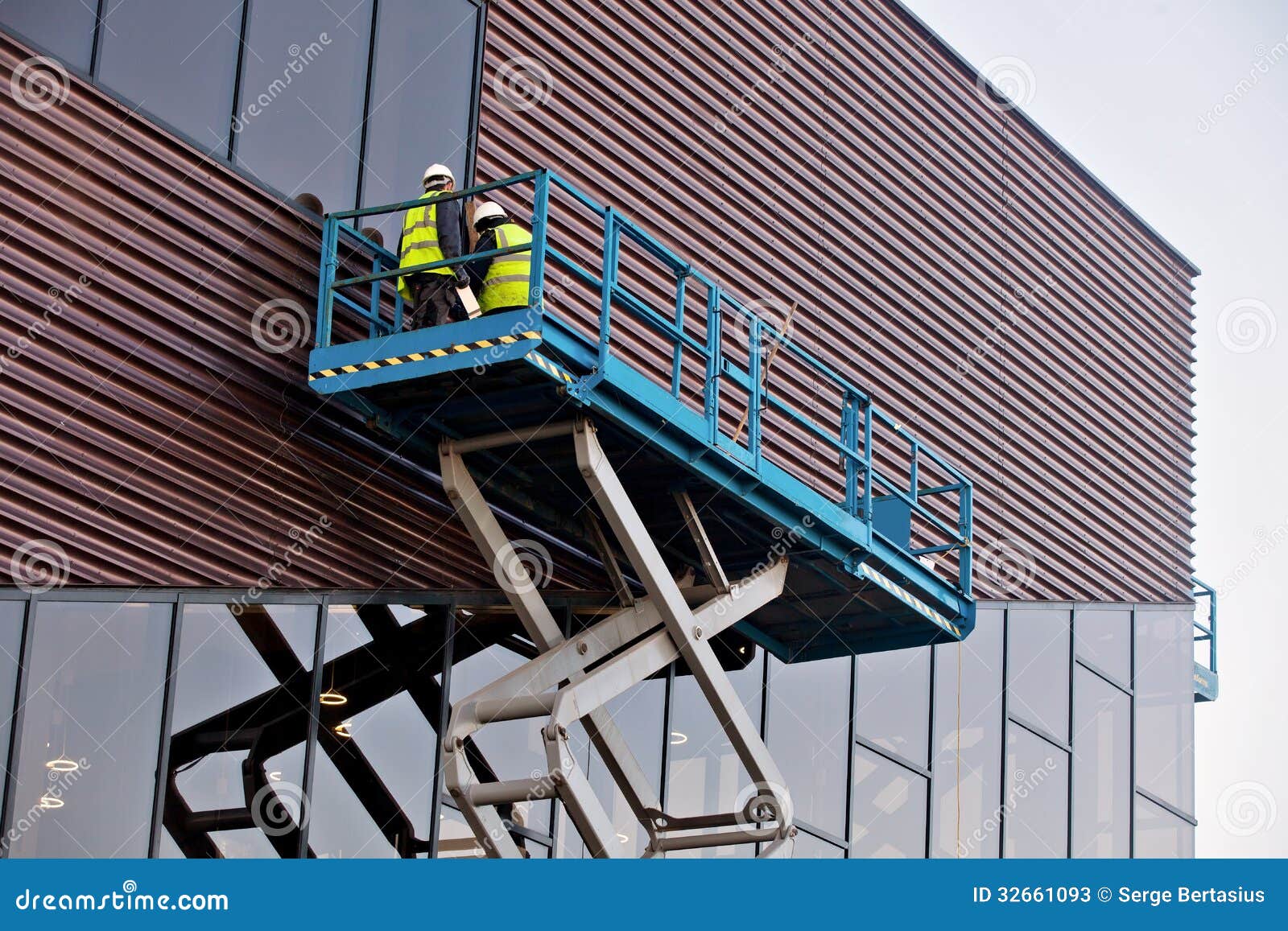 Builder on a Scissor Lift Platform at a Construction Site Stock Image ...