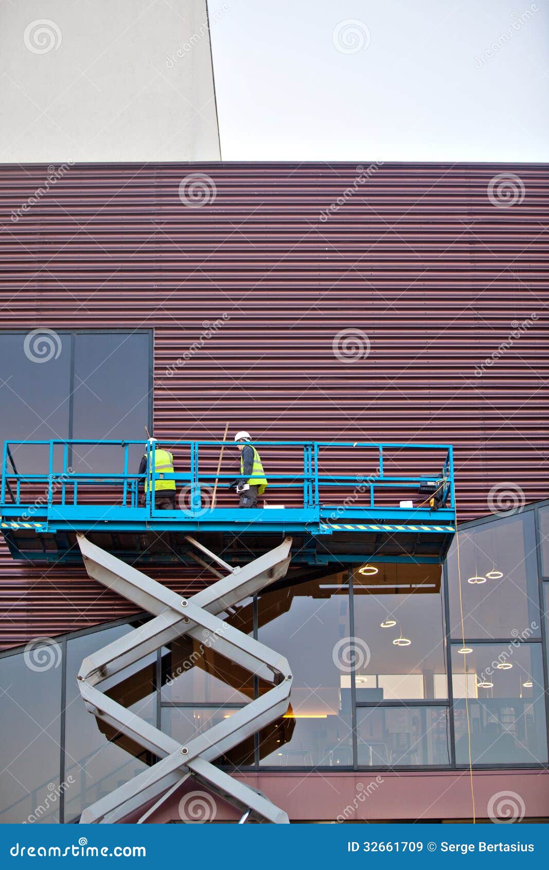 Builder On A Scissor Lift Platform At A Construction Site Stock Image ...