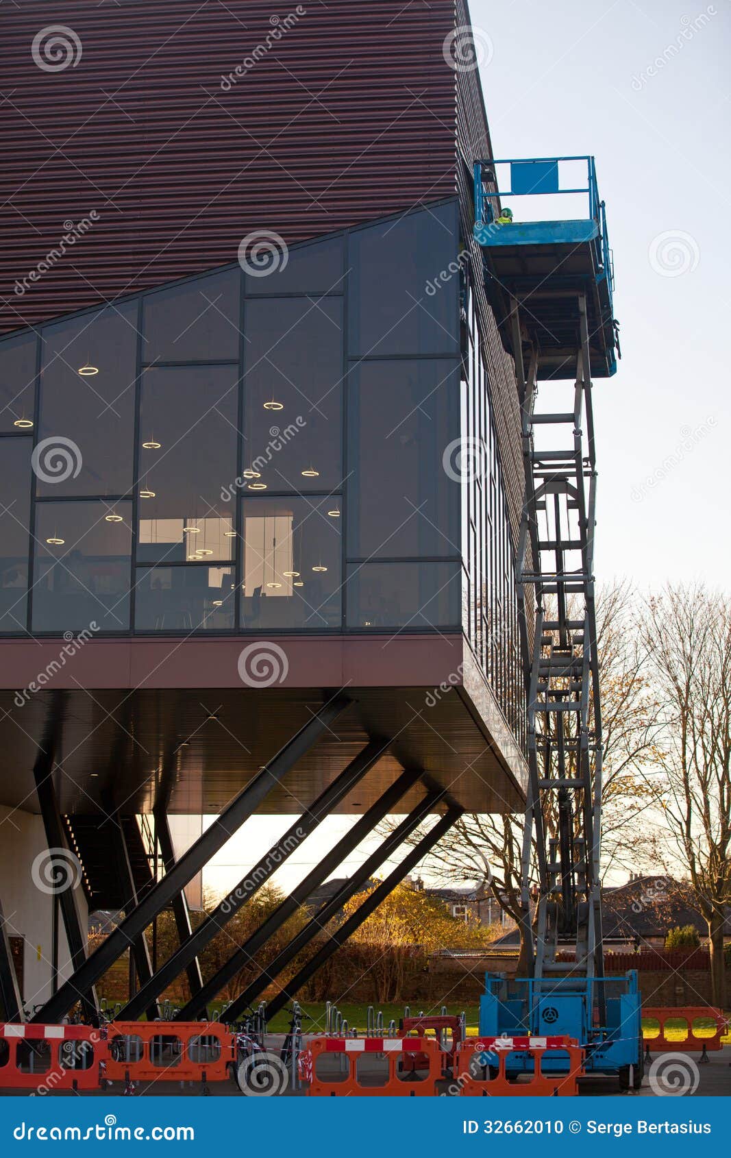 Builder on a Scissor Lift Platform at a Construction Site Stock Photo ...