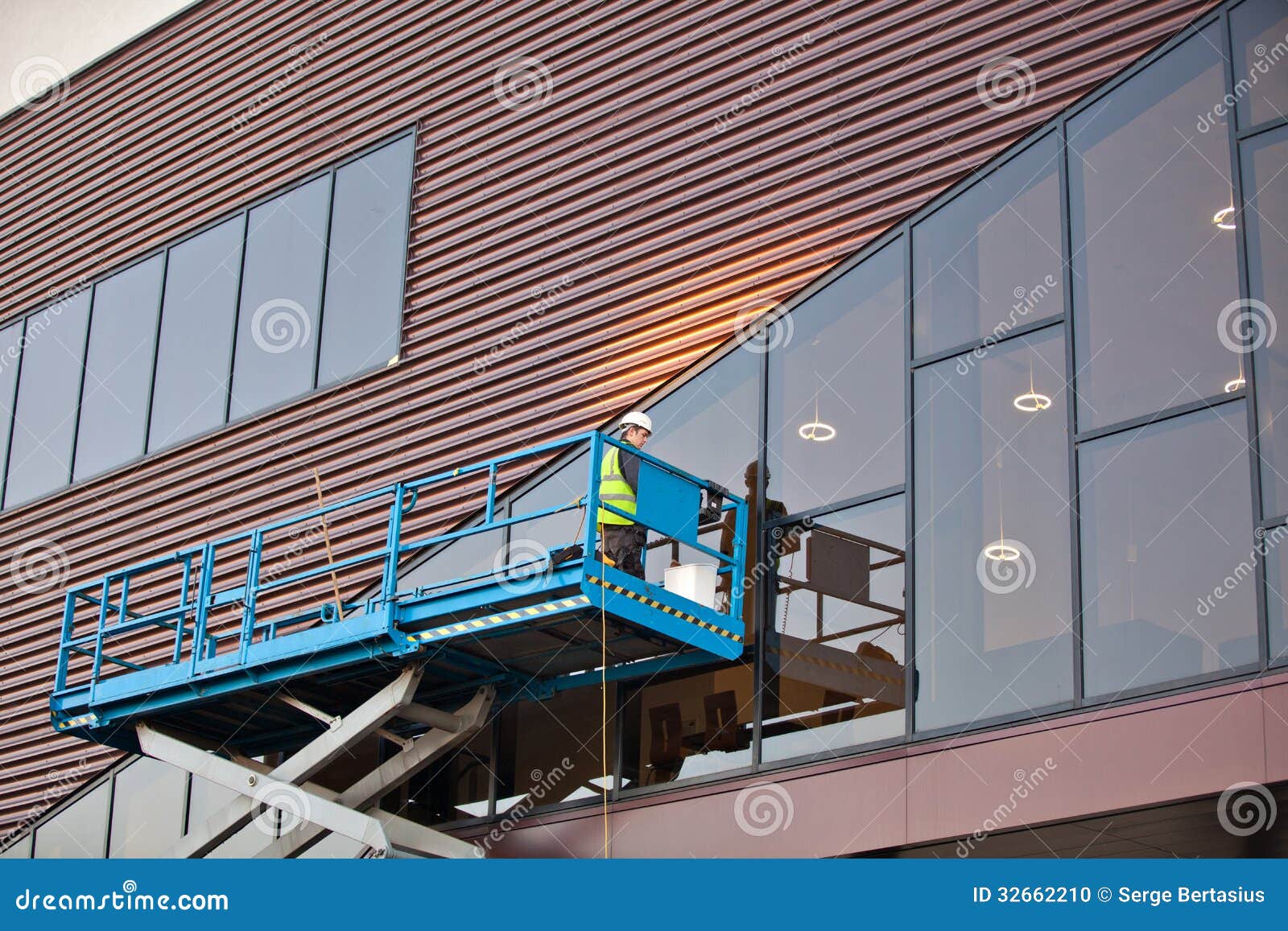 Builder on a Scissor Lift Platform at a Construction Site Stock Photo ...