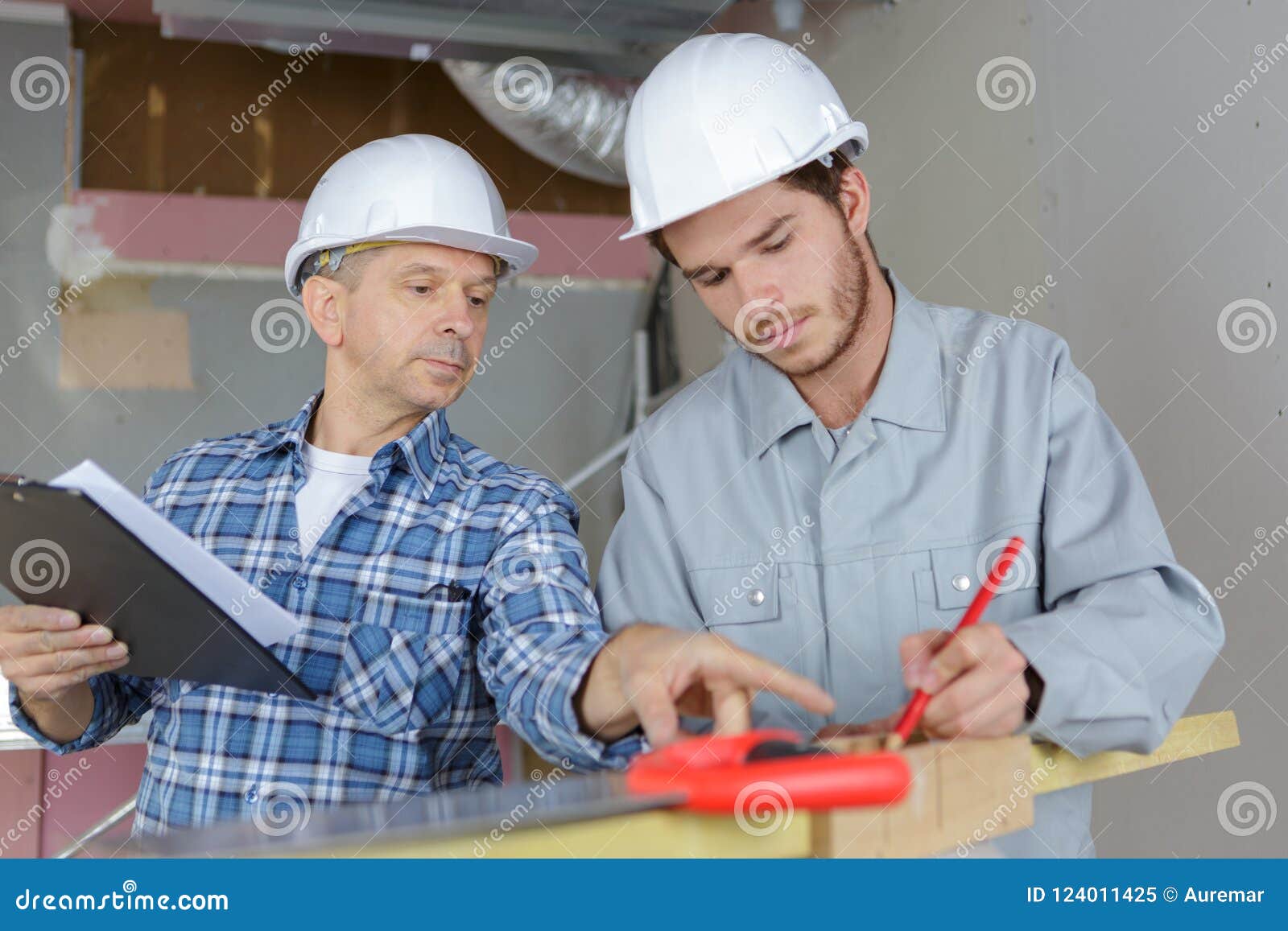 Builder Showing Apprentice Where To Cut Stock Image - Image of builder ...