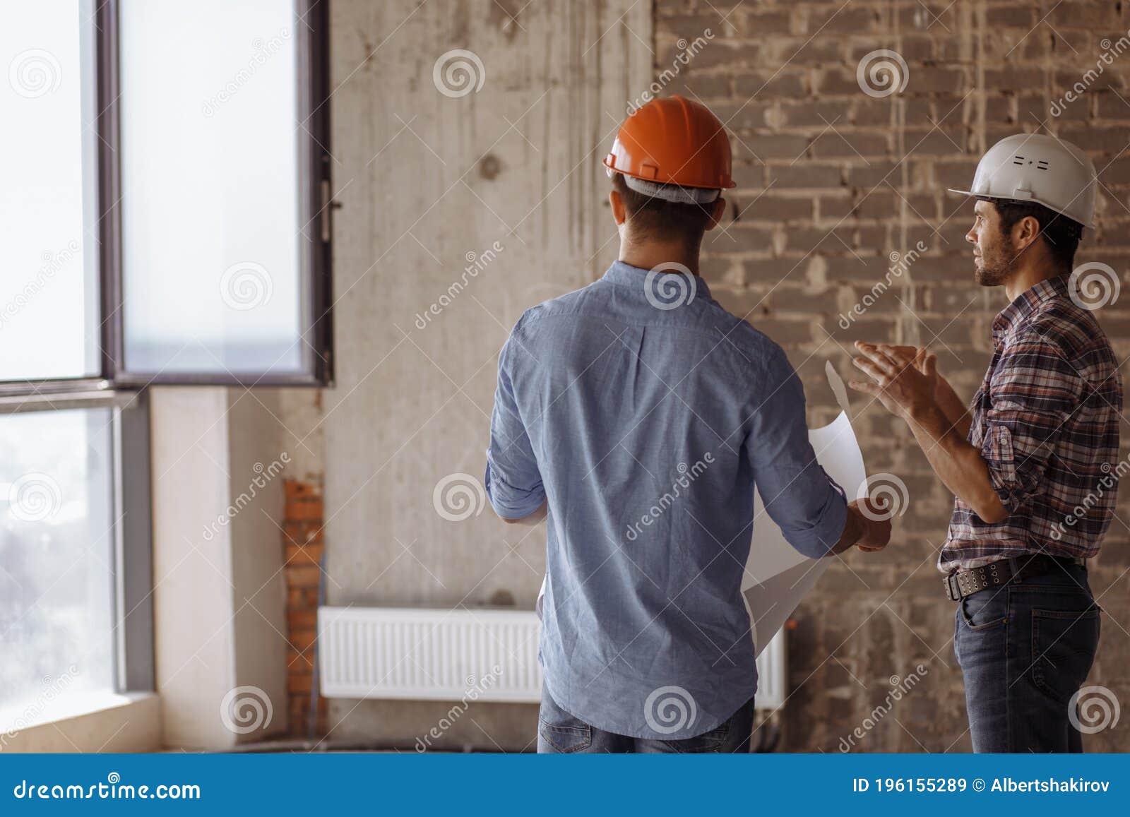 Builder is Showing the Successful Result of Work To a Client Stock ...