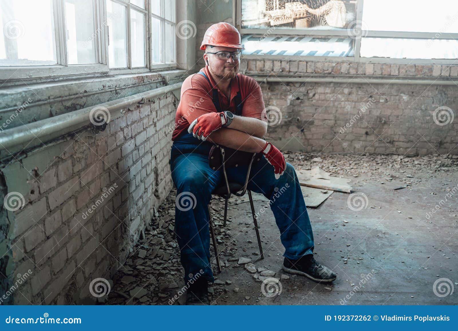Builder Sitting on a Chair in the Middle of a Construction Site Stock ...