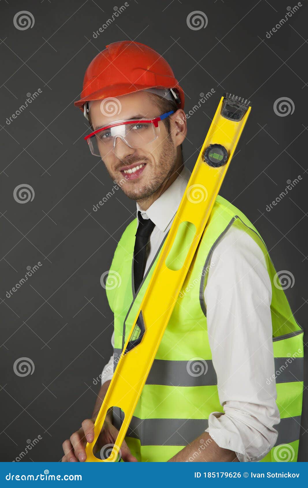 Builder Smiling and Holding a Ruler Stock Photo - Image of portrait ...