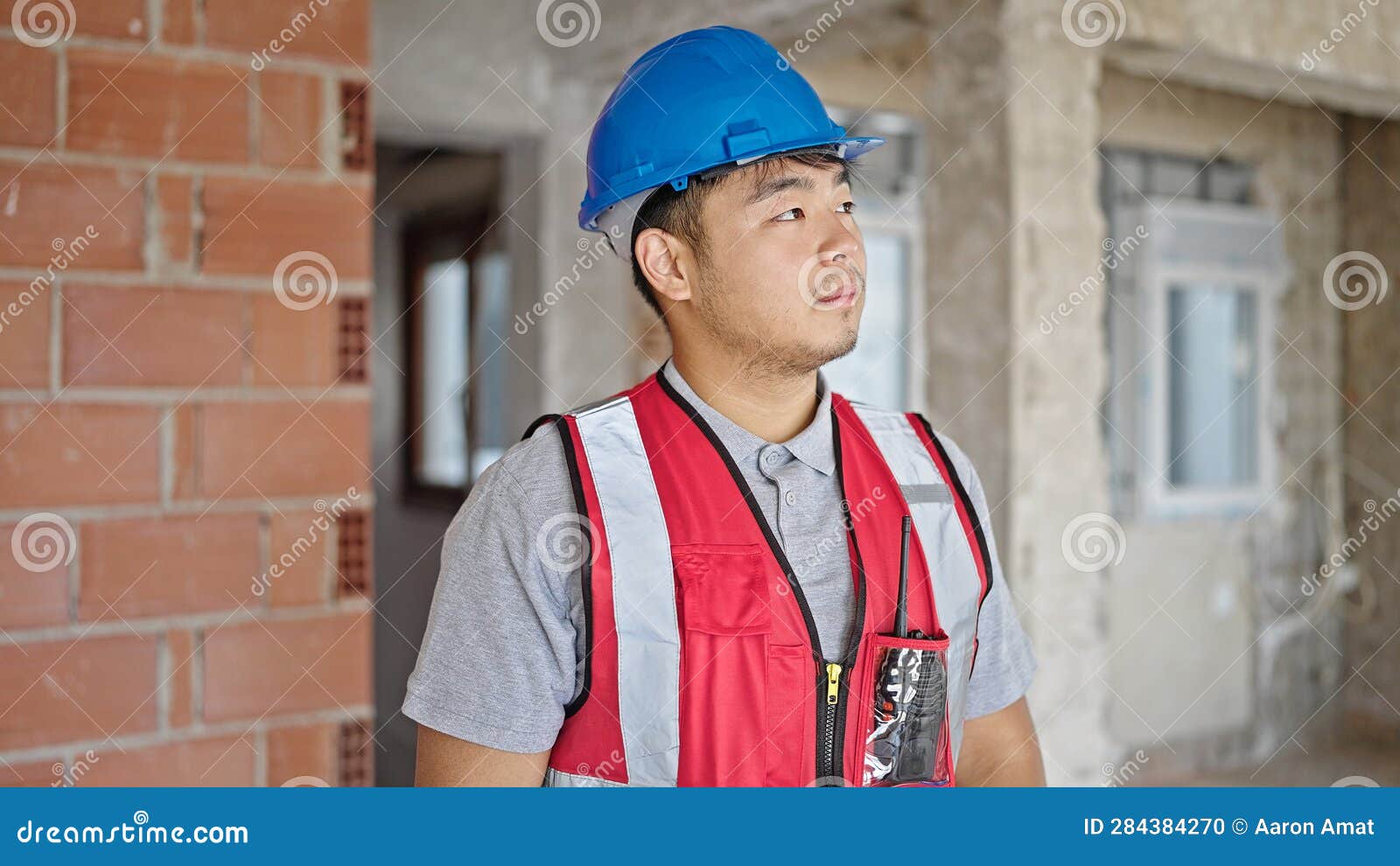Builder Standing with Serious Expression at Construction Site Stock ...