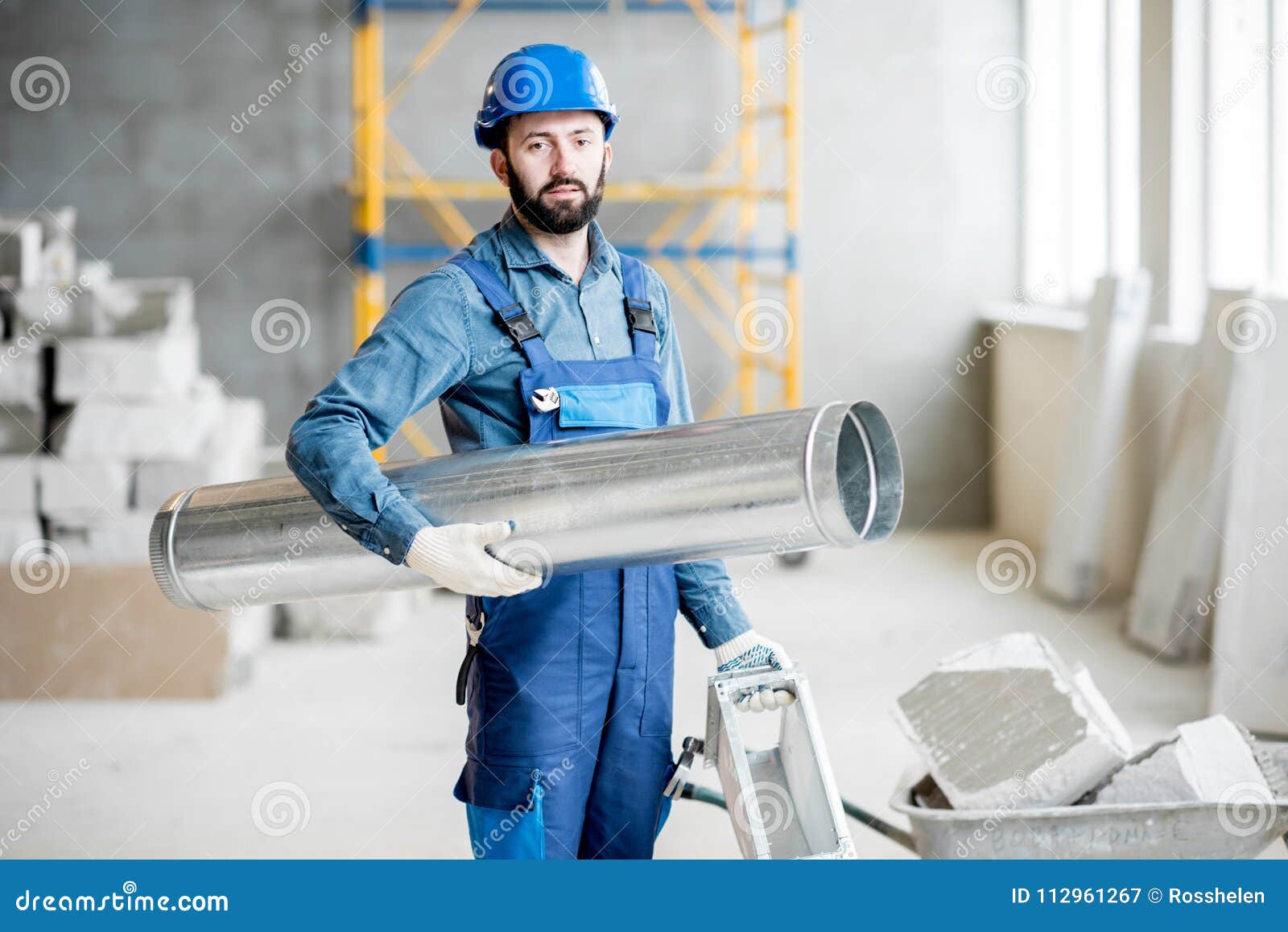 Builder with pipe indoors stock image. Image of conditioning - 112961267