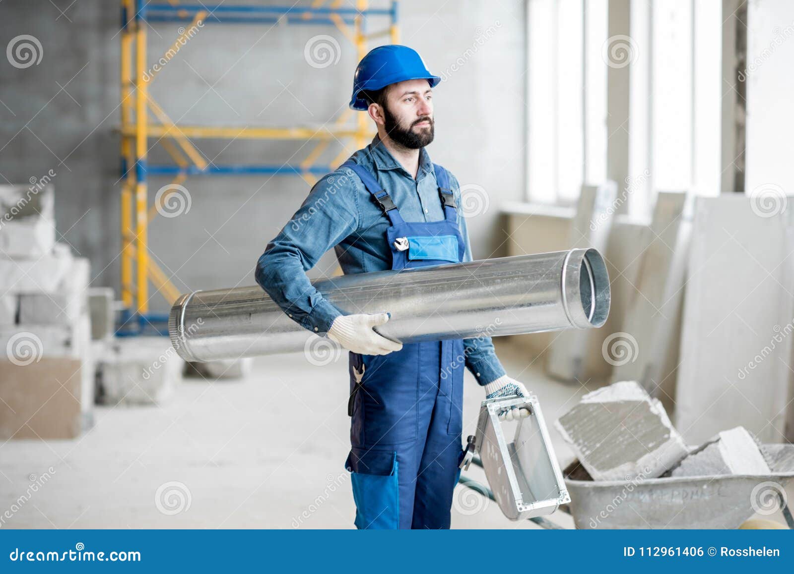 Builder with pipe indoors stock photo. Image of installation - 112961406