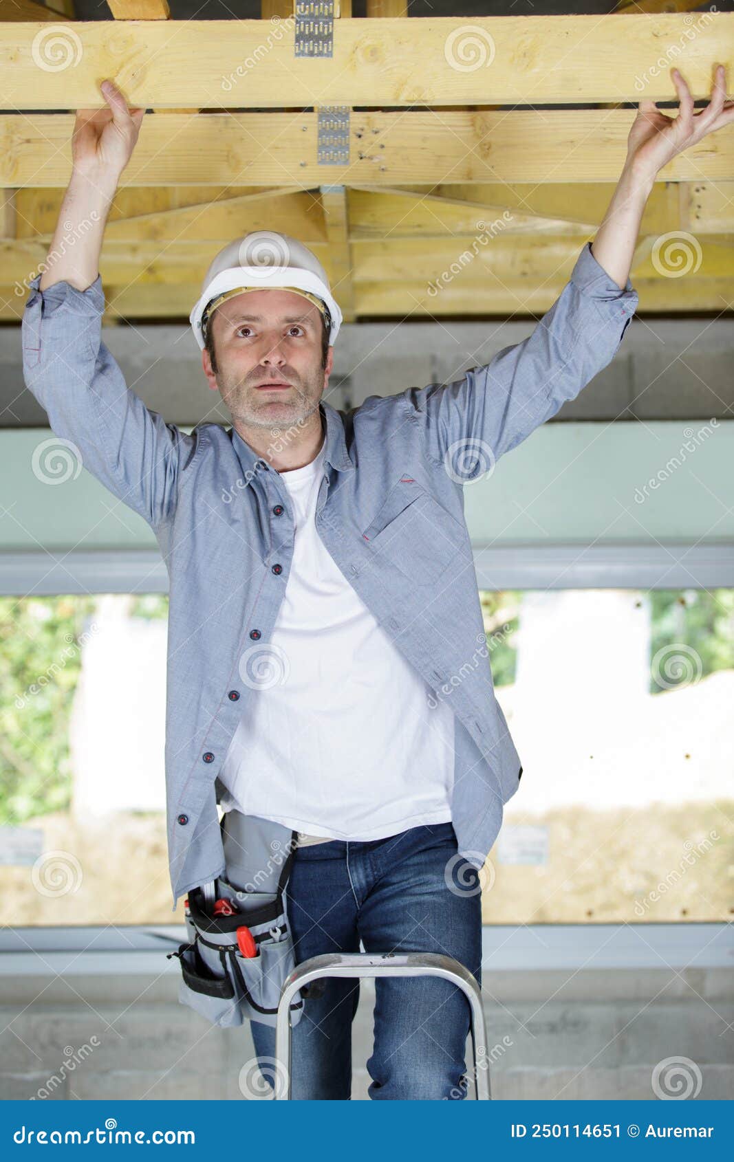 Builder on Stepladder Reaching Up To Roof Timber Stock Image - Image of ...