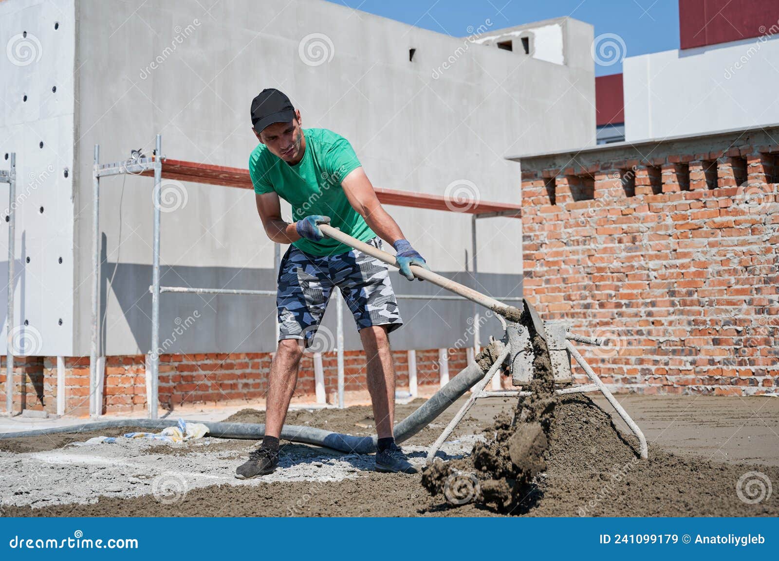 Builder Using Concrete Screed Mixer Machine at Construction Site. Stock ...