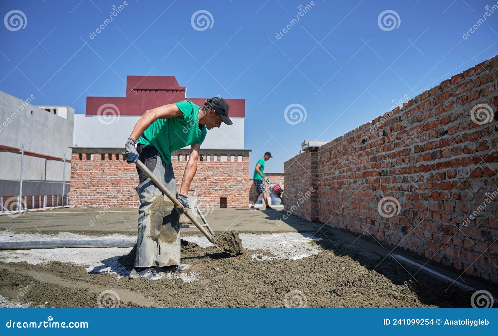 Builder Using Concrete Screed Mixer Machine at Construction Site. Stock ...