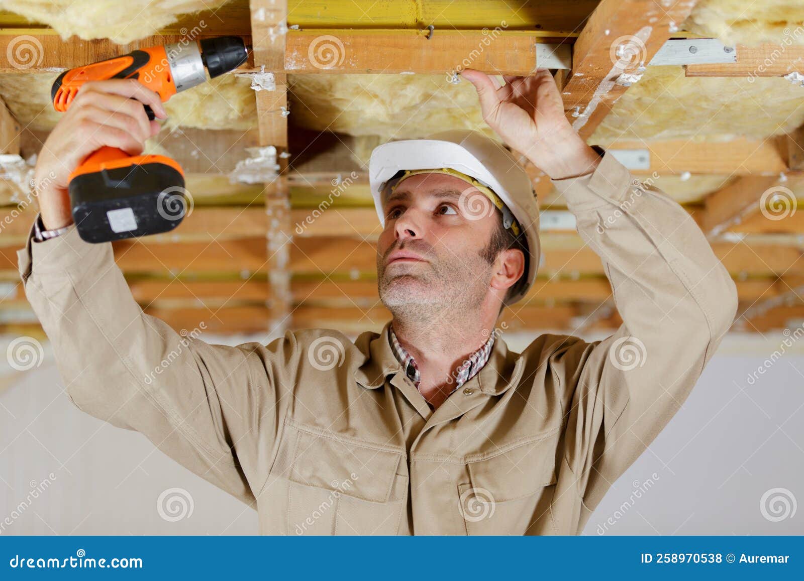 Builder Using Cordless Drill on Rafter Stock Photo - Image of ...