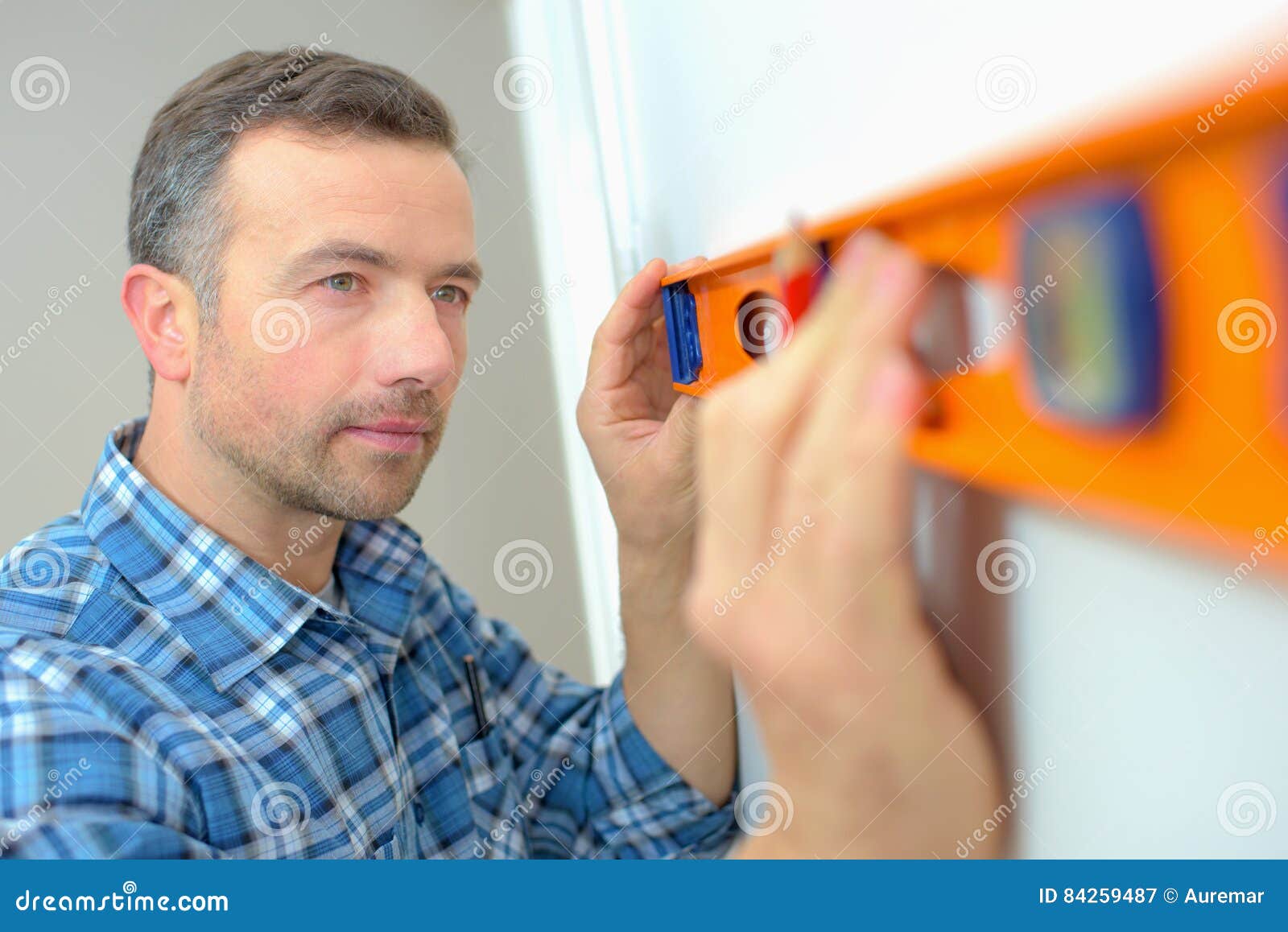 Builder using spirit level stock image. Image of contractor - 84259487