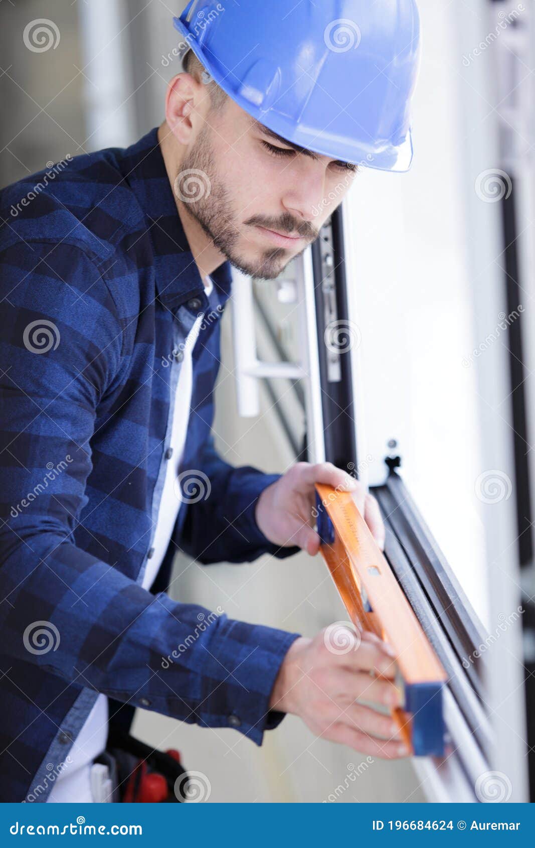 Builder Using Spirit Level on Construction Site Wall Stock Photo ...