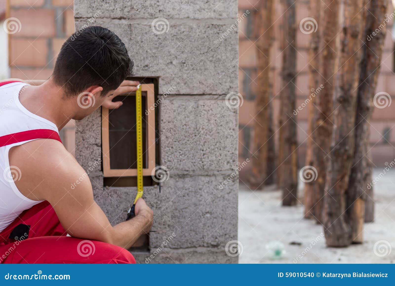 Builder using tape measure stock photo. Image of labour - 59010540