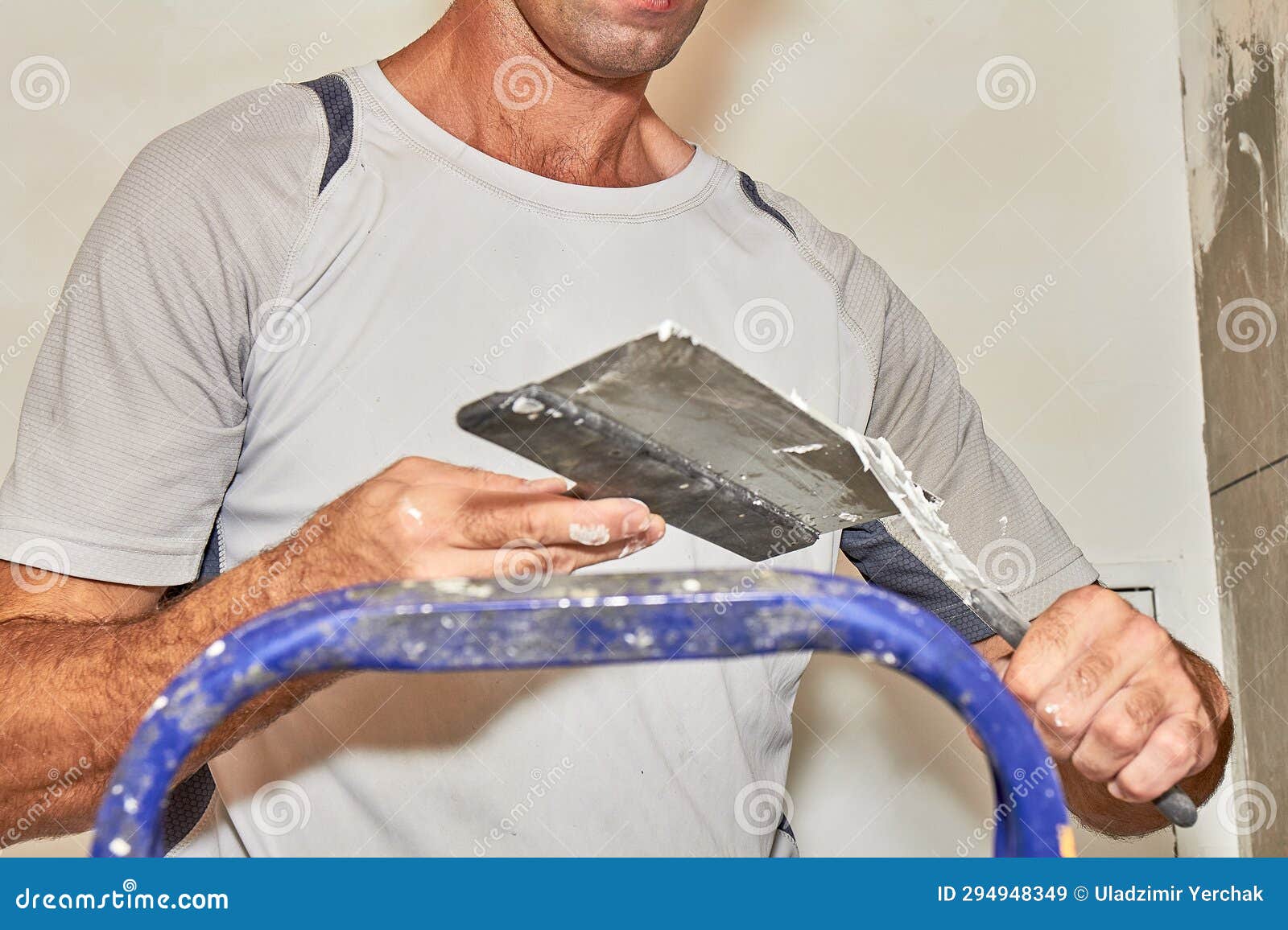 Builder Using a Trowel To Add Plaster.Close-up of a Spatula with a ...