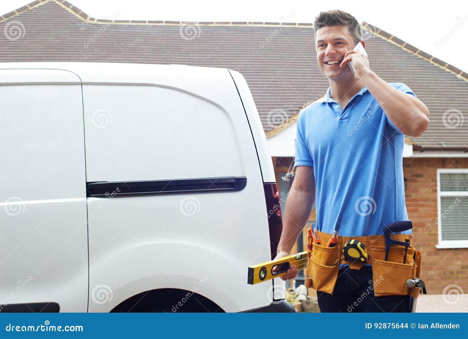 Builder with Van Talking on Mobile Phone Outside House Stock Photo ...