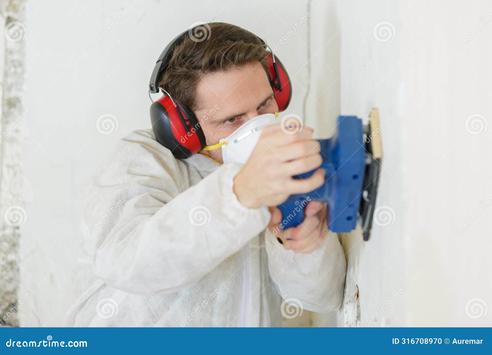 Builder Wearing Dust Mask Using Sander on Wall Surface Stock Photo ...