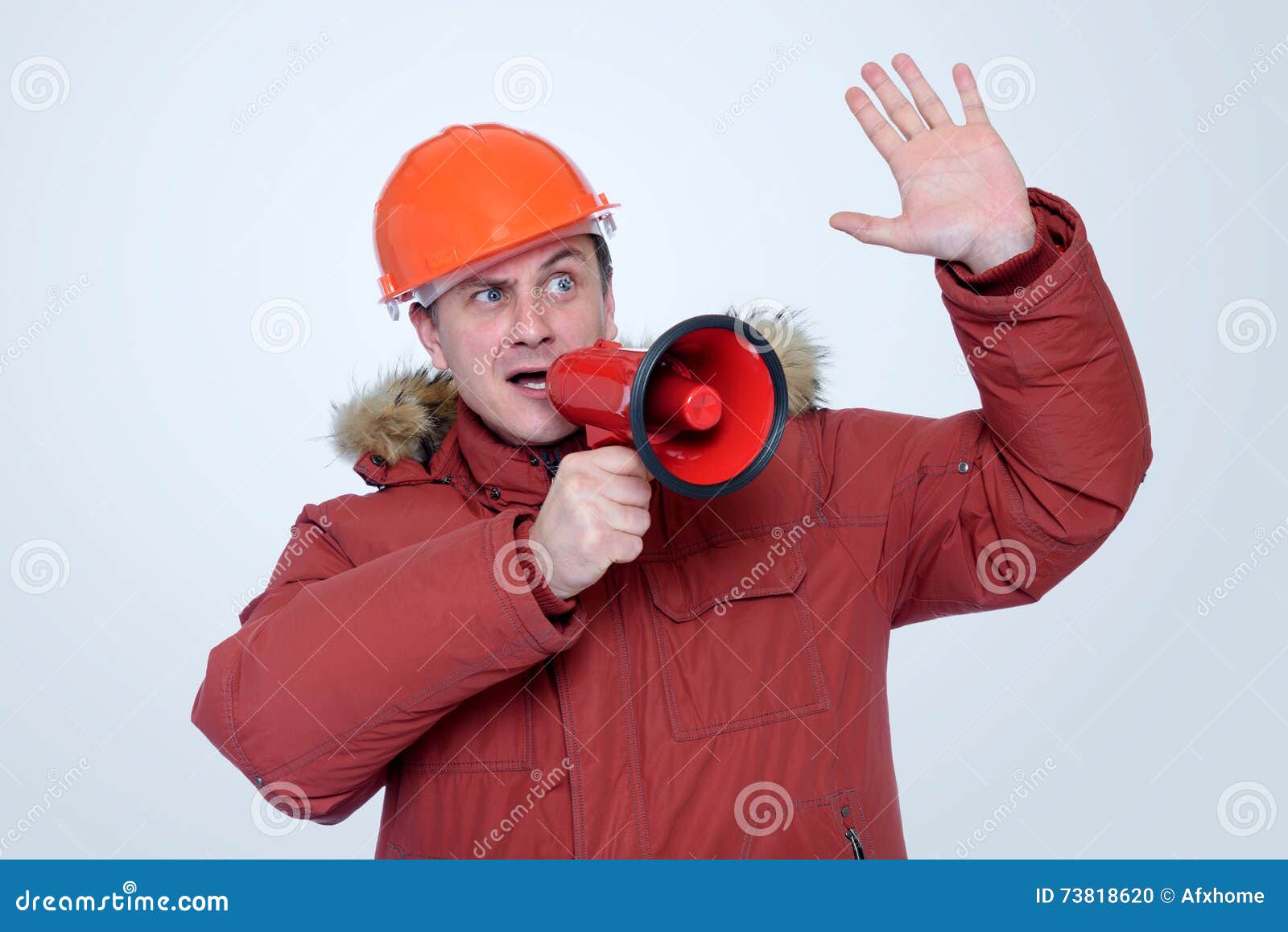 Builder in Winter Clothes Shouting through a Megaphone, and Shows His ...