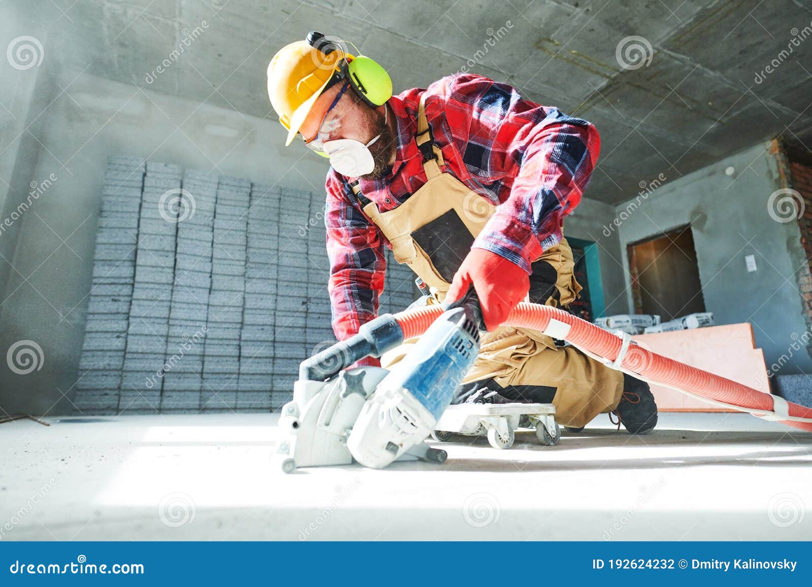 Builder at Work. Cutting Concrete Floor for Cabling by Diamond Slitting ...