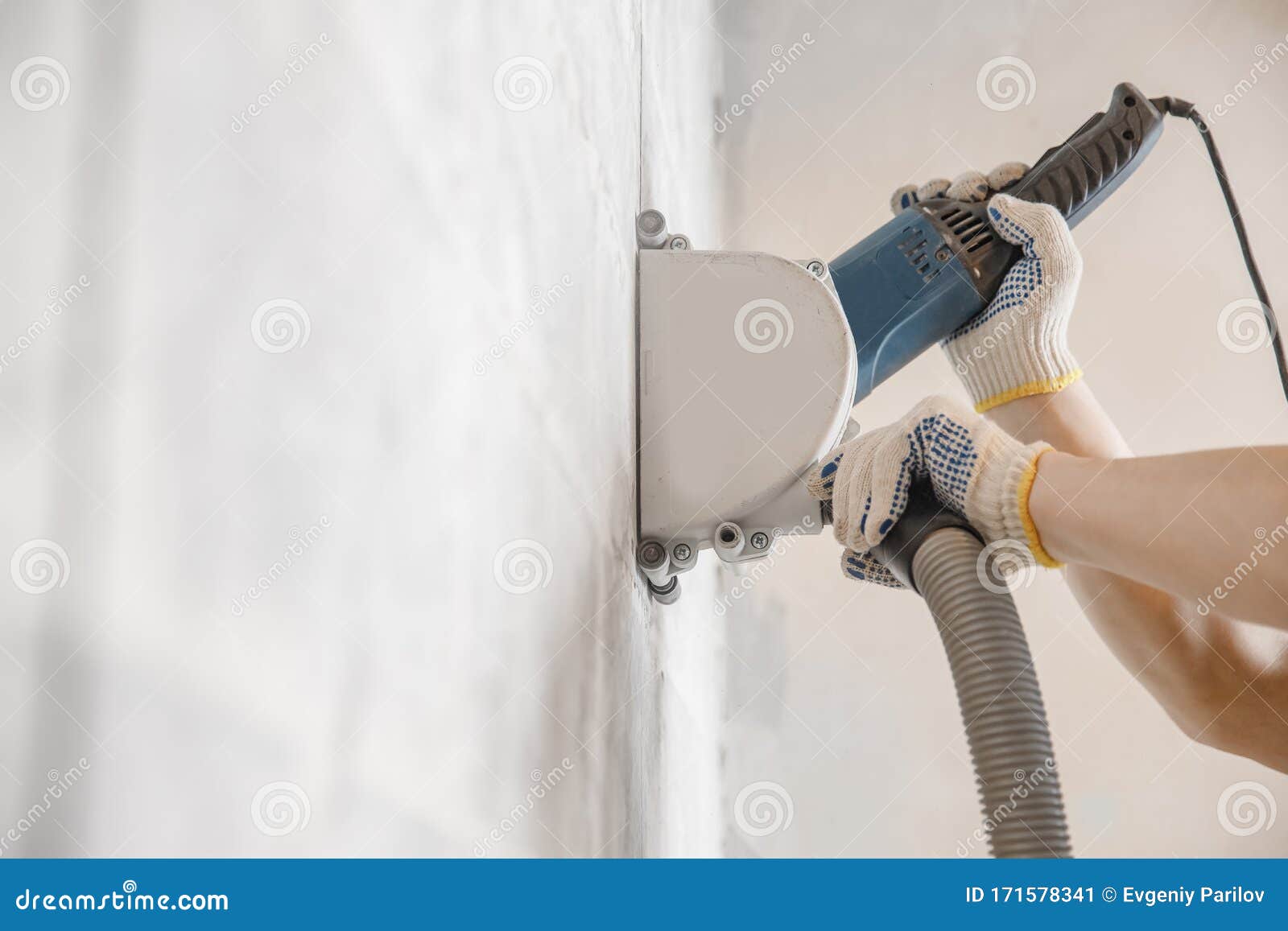Builder Worker Cutting Electrical Chase in Concrete Wall with ...