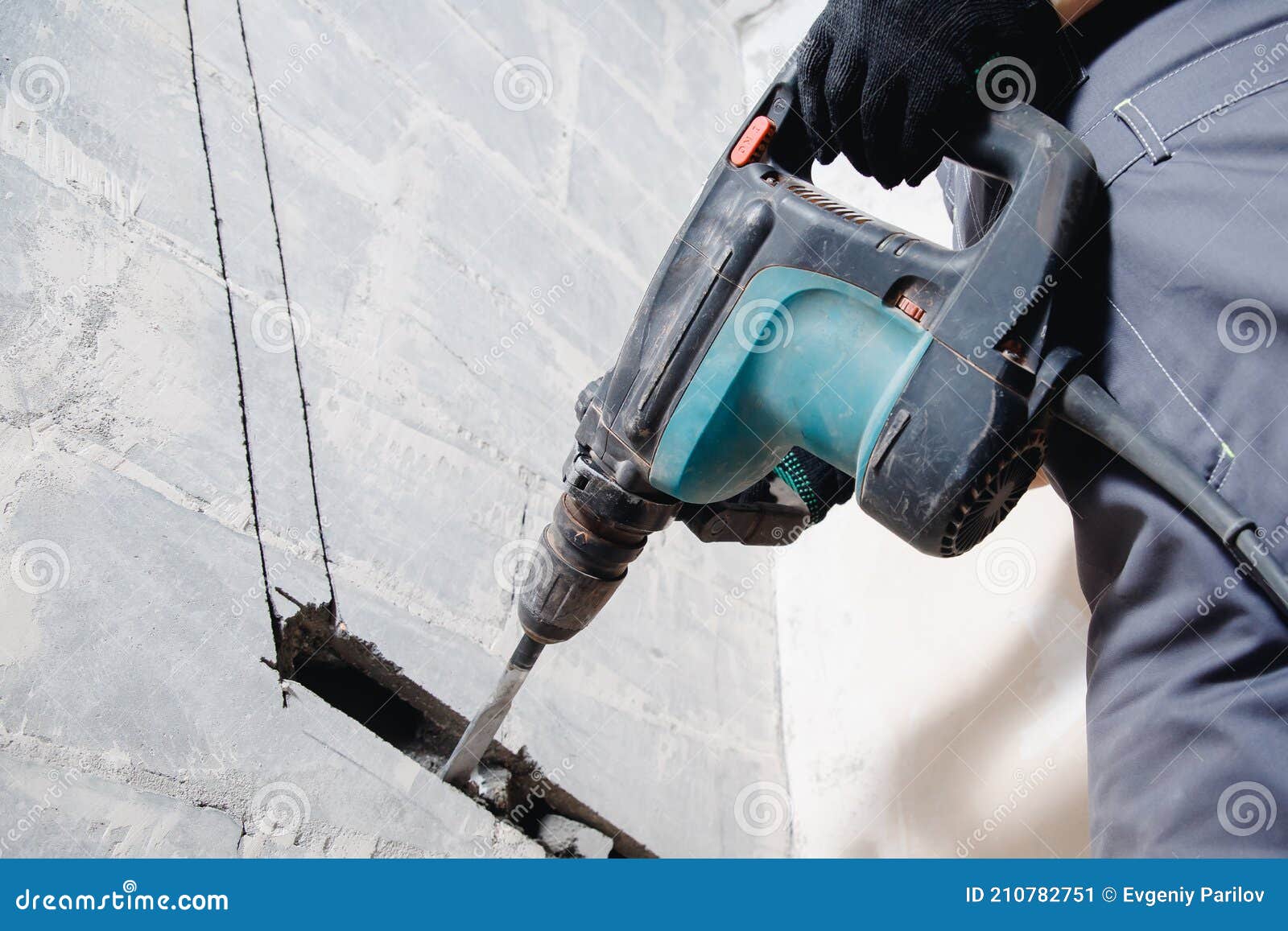 Builder Worker Man Using Jackhammer To Drill into Construction Wall for ...