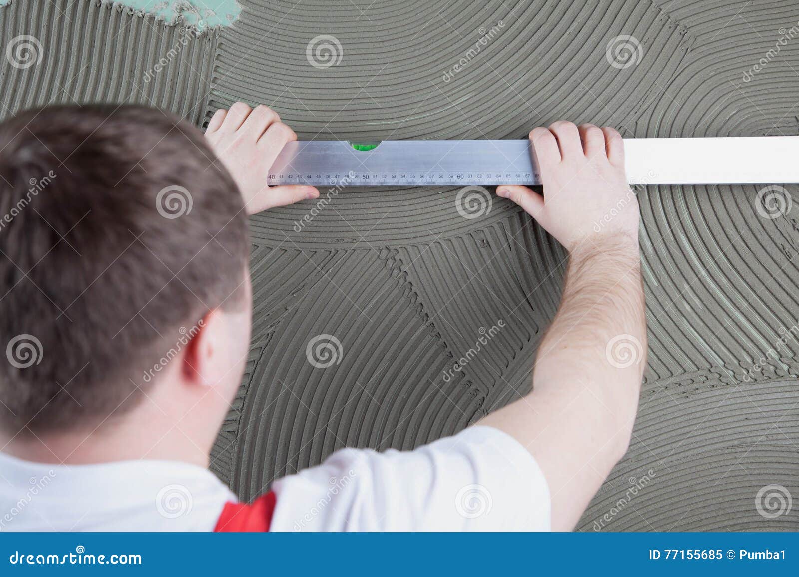 Builder Worker Measuring Level of Wall Construction with Special Stock ...