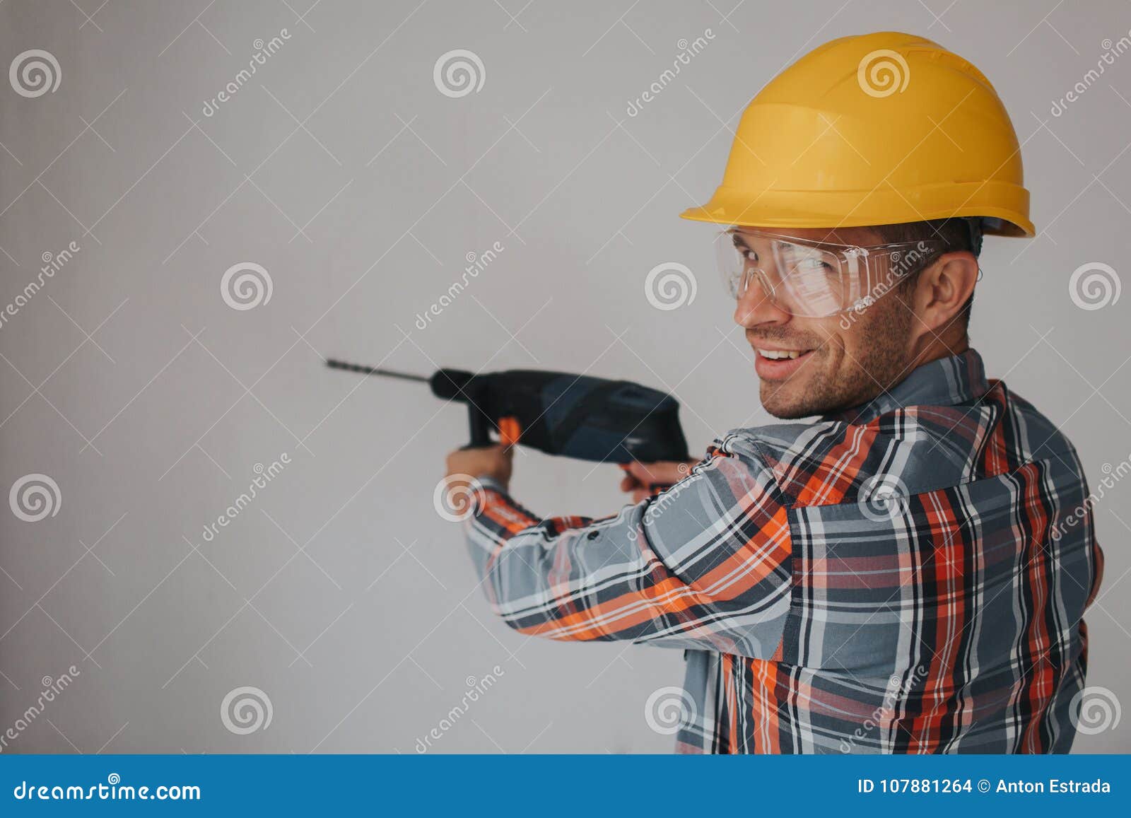 Builder Worker with Equipment Making Hole in Wall at Construction Site ...