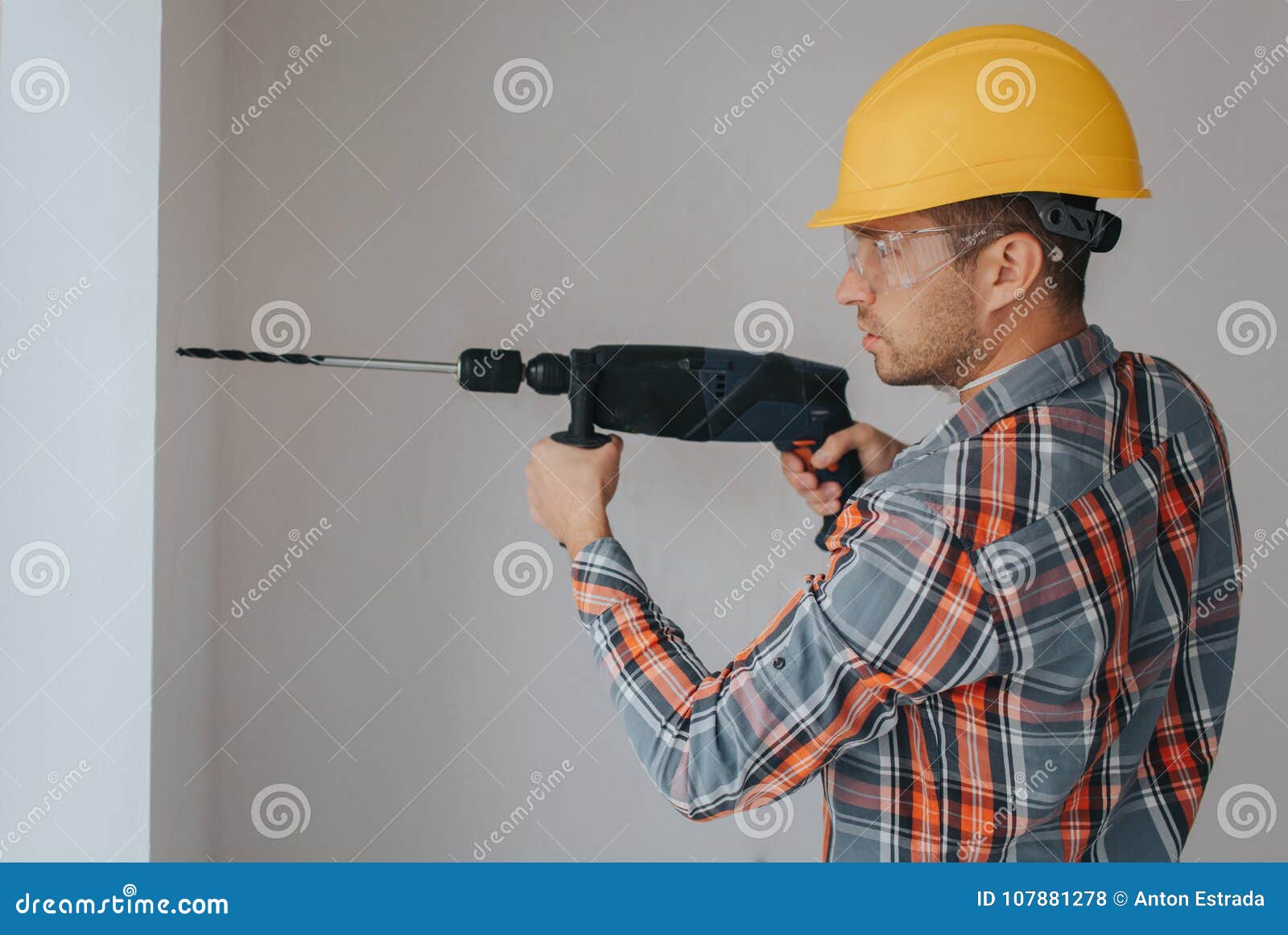 Builder Worker with Equipment Making Hole in Wall at Construction Site ...