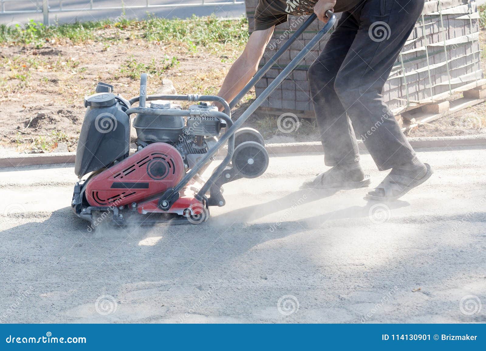 Builder Worker at Sand Ground Compaction with Vibration Plate Compactor ...