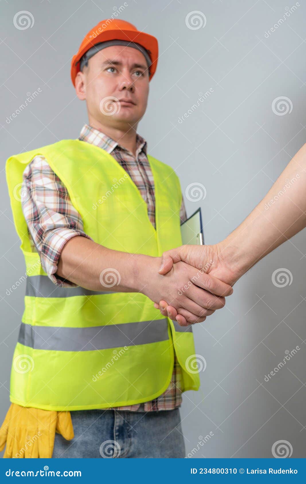 A Builder, a Worker Shaking Hands with a Client To Negotiate the ...