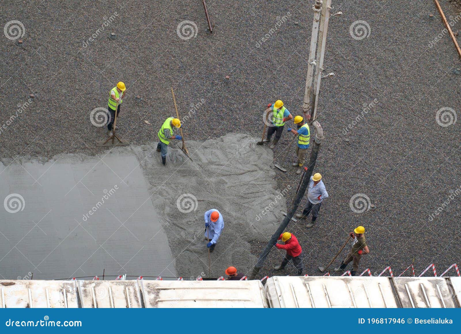 Builder Workers Pouring Concrete on the Ground at Construction Site ...