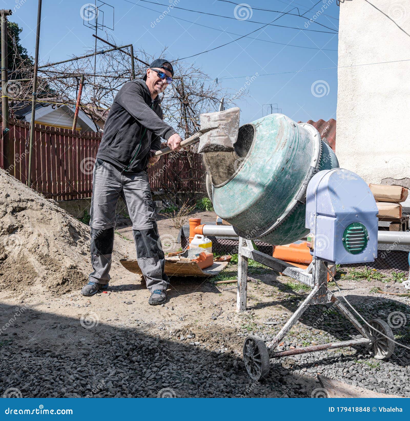 Worker With Shovel Is Digging A Pit On Construction Site. Concept Of ...