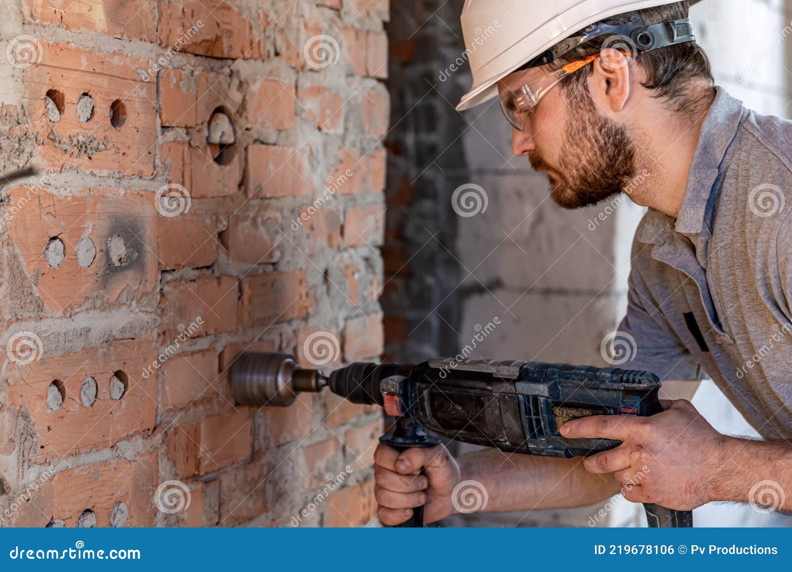 The Builder Works with a Drill in Working Form Stock Photo - Image of ...