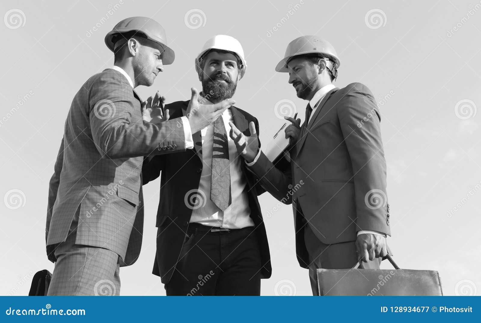 Builders Discussing Plan and Argue, Blue Sky Background. Stock Image ...