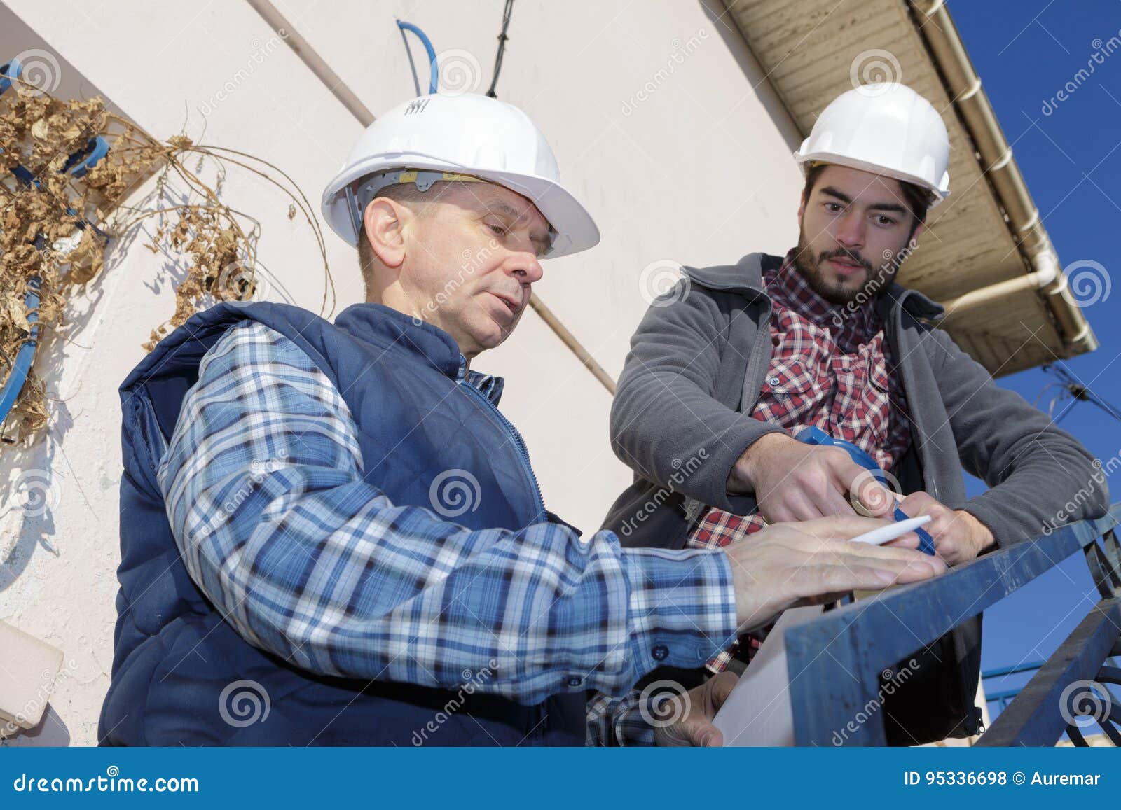 Builders Discussing Something Outside Construction Site Stock Photo ...