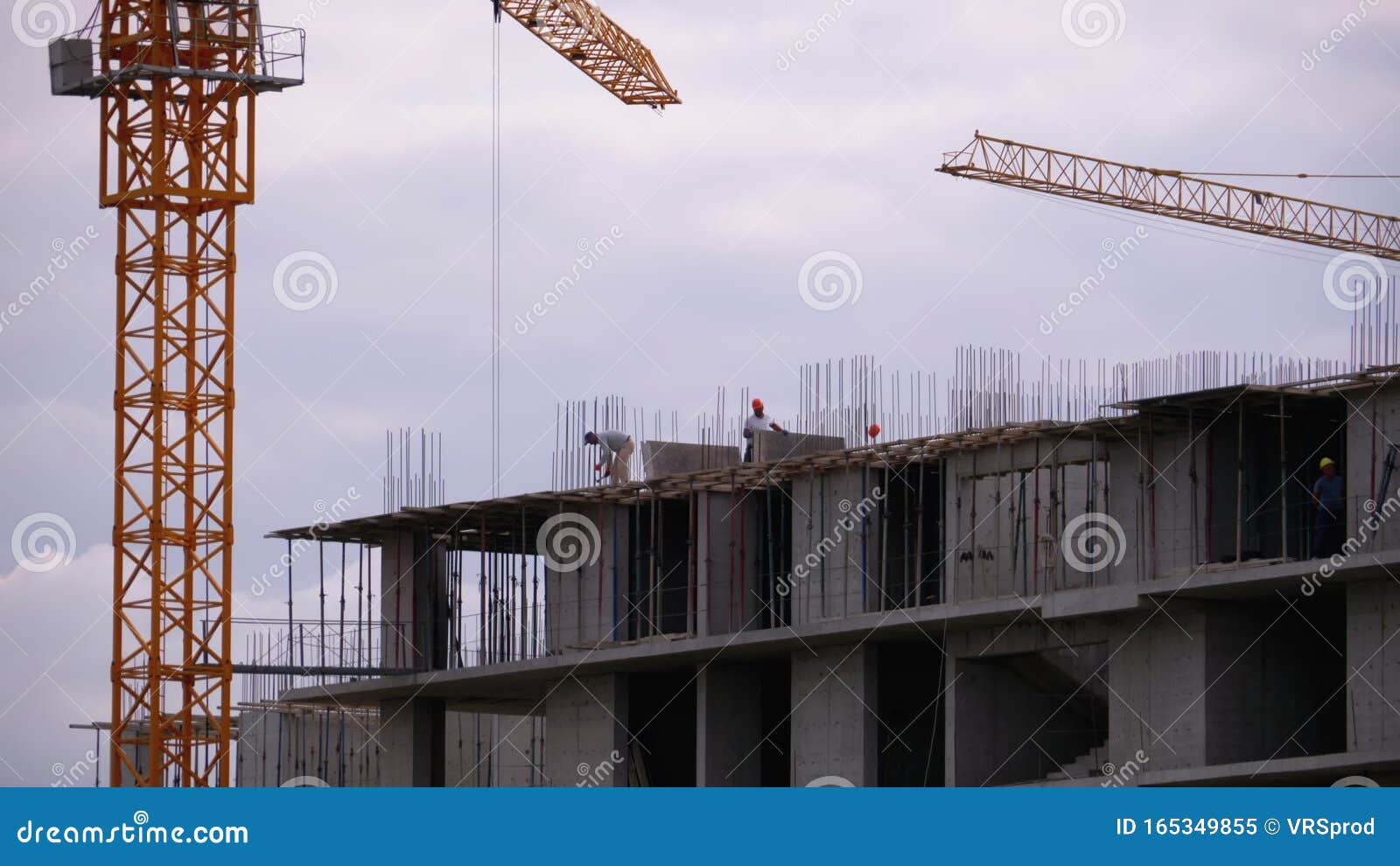 Builders on the Edge of a Skyscraper Under Construction. Workers at a ...