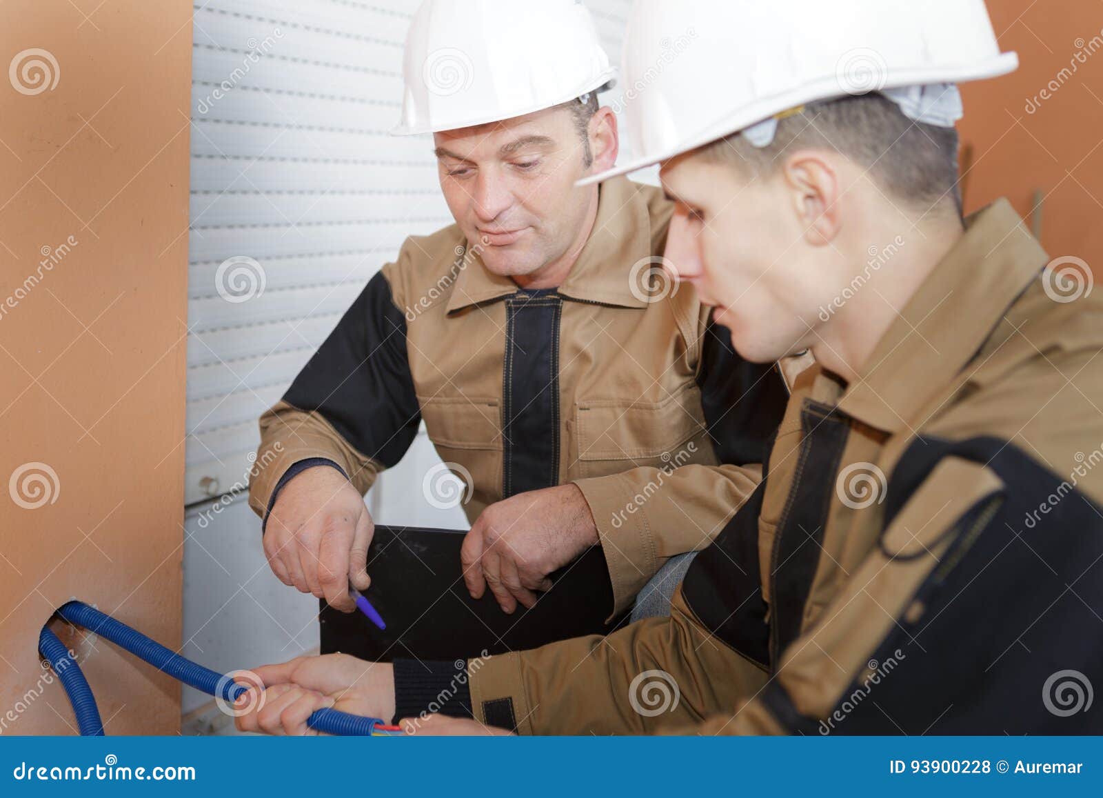 Builders Holding Hose Pipe Insulation on Hot Water Pipes Stock Photo ...