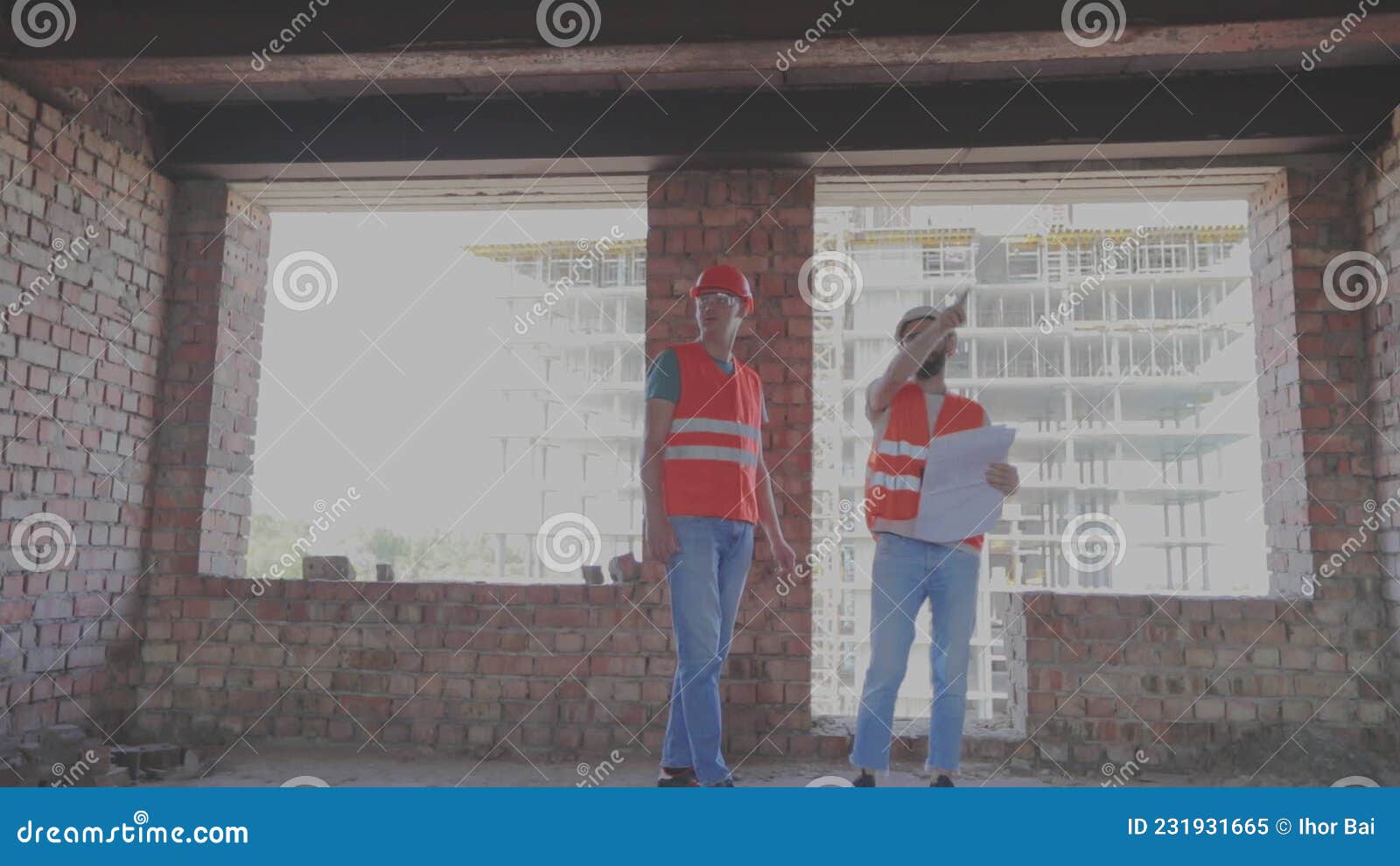 Builders Inside a New Building. Engineers with a Blueprint Inside a New ...
