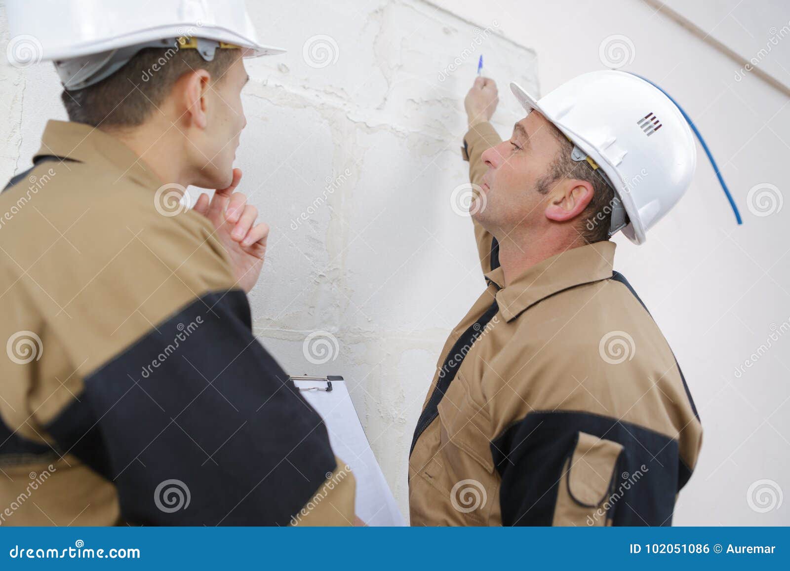 Builders Inspecting Even Level Wall Stock Photo - Image of engineer ...