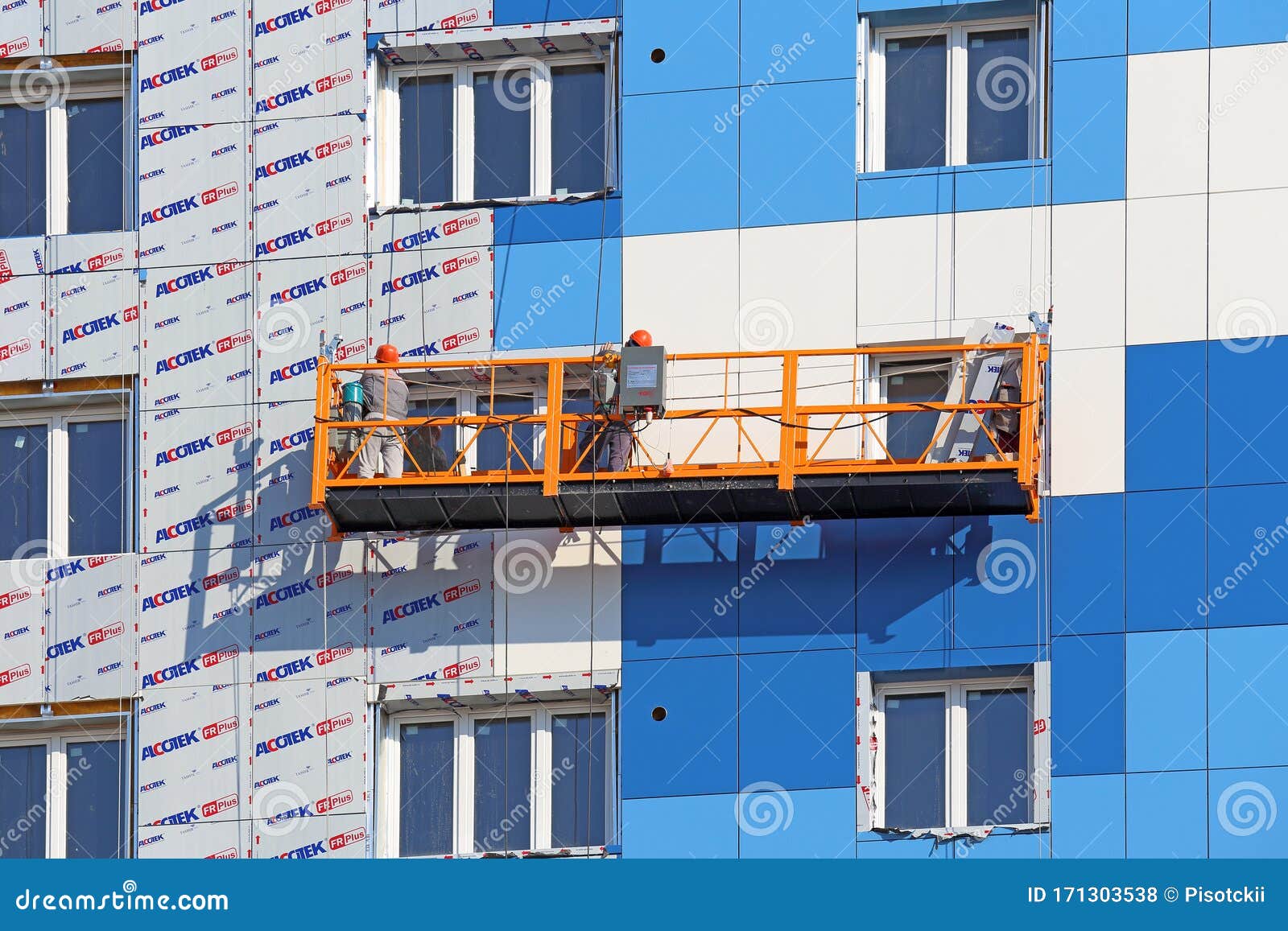 Builders Install White and Blue Panels on the Facade of a Multi-storey ...