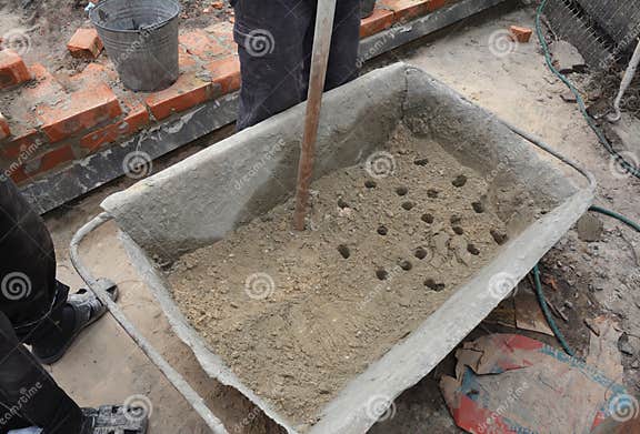 Builders Making Construction Concrete Mixing Sand and Cement Stock ...