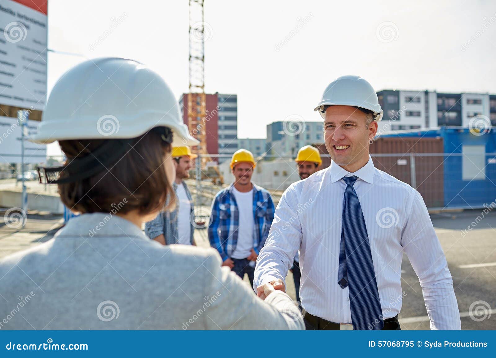 Builders Making Handshake on Construction Site Stock Image - Image of ...