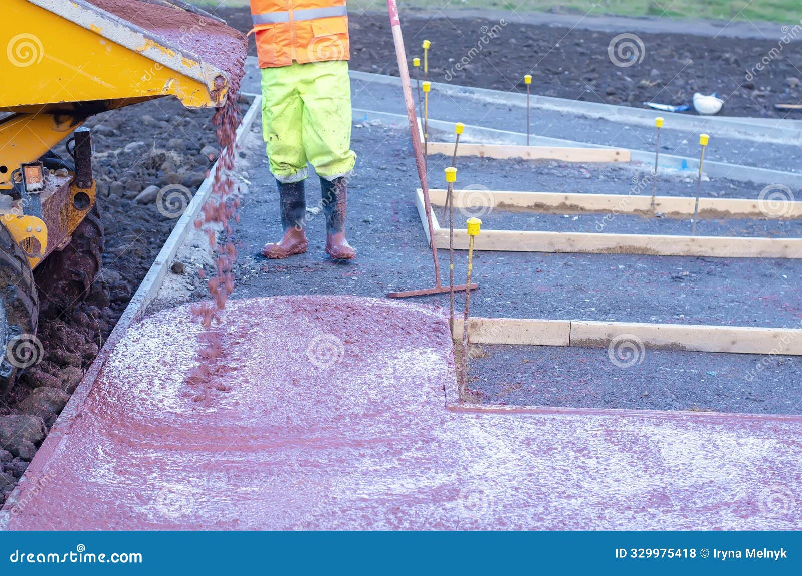 Builders Pouring and Levelling Wet Ready-mix Concrete into Formwork ...