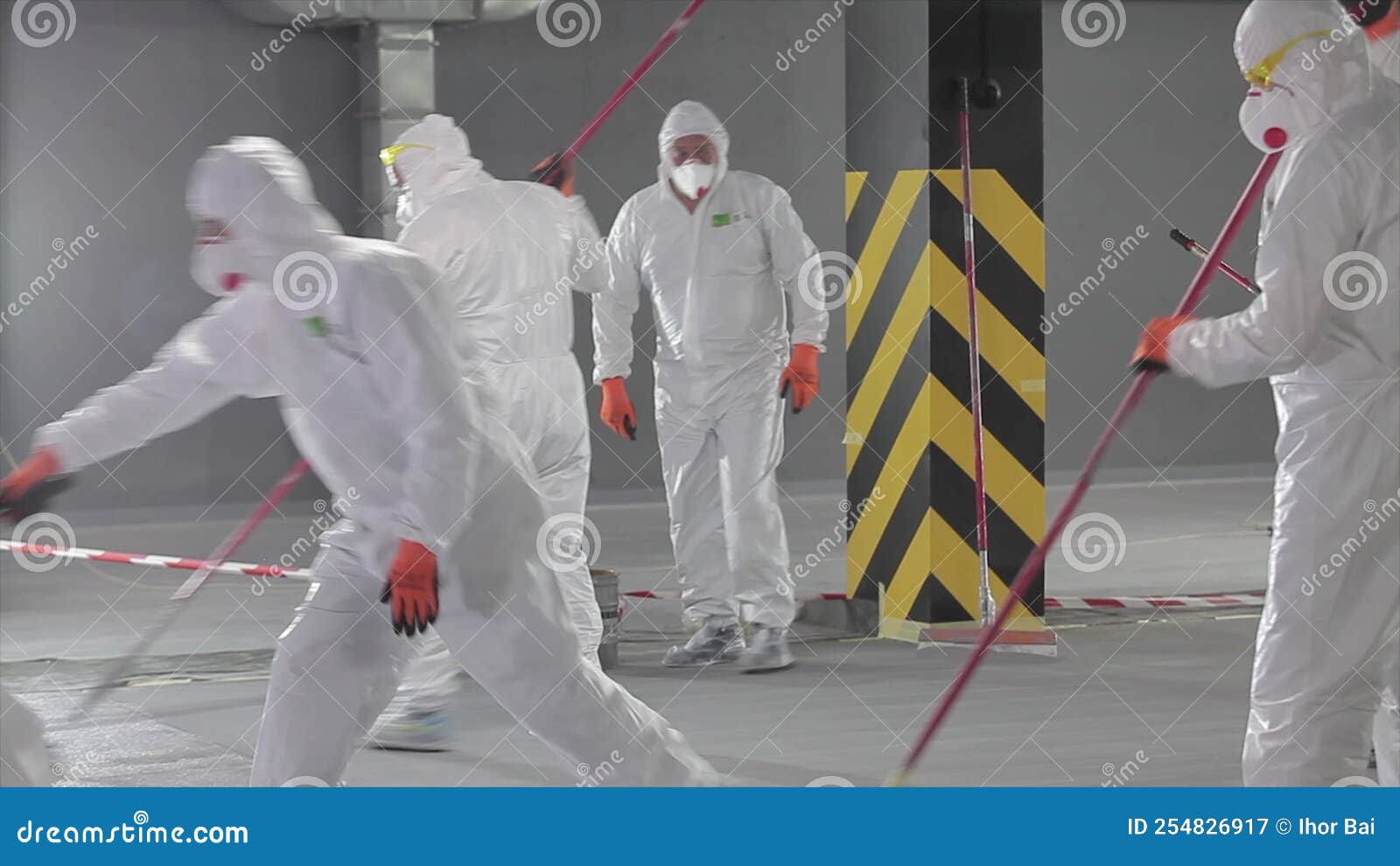 Builders in Protective Suits at the Construction Site. Professional ...