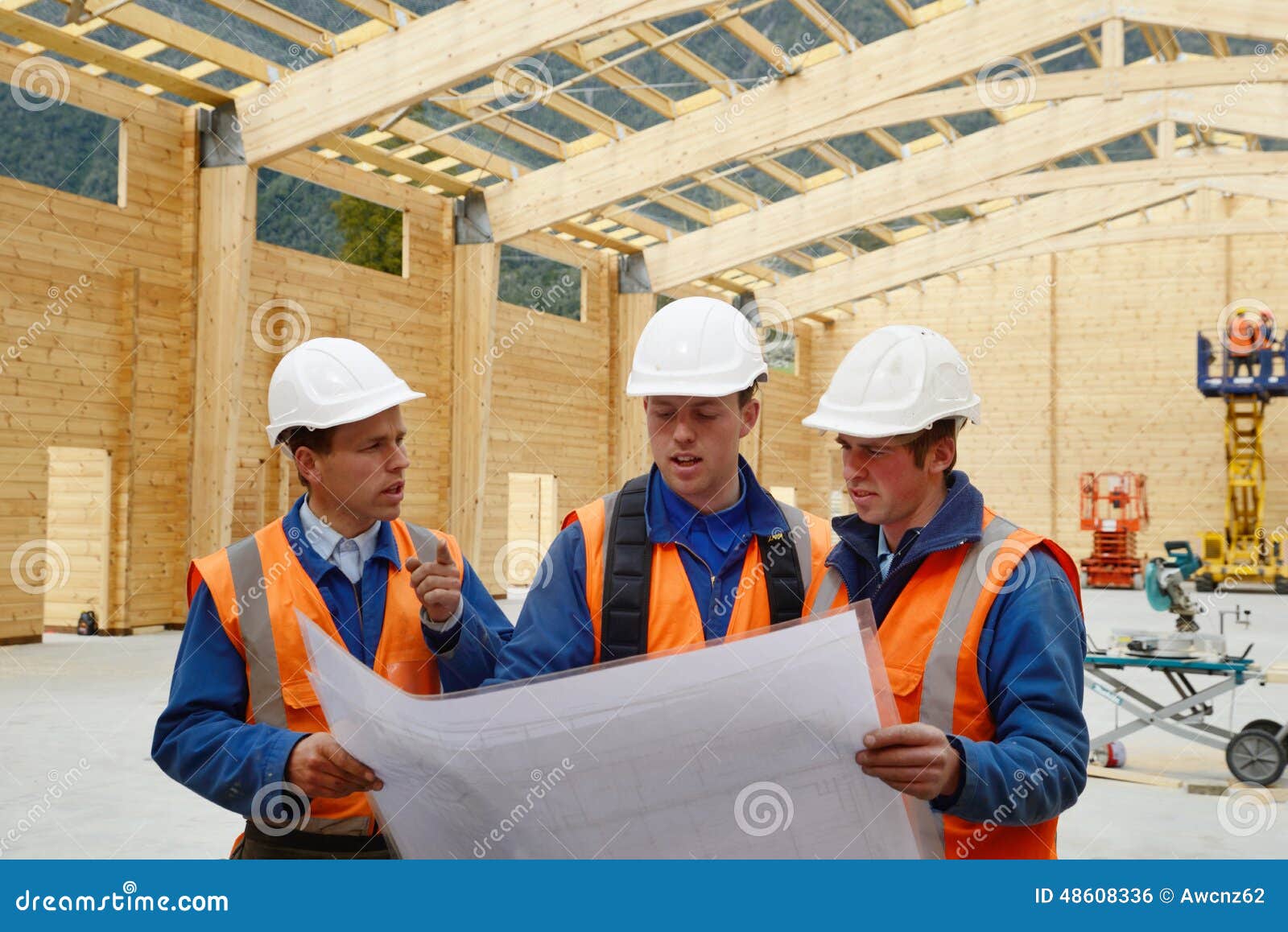 Builders study the plan stock photo. Image of builder - 48608336