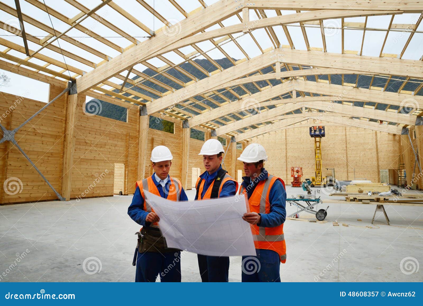 Builders study the plan stock image. Image of helmet - 48608357