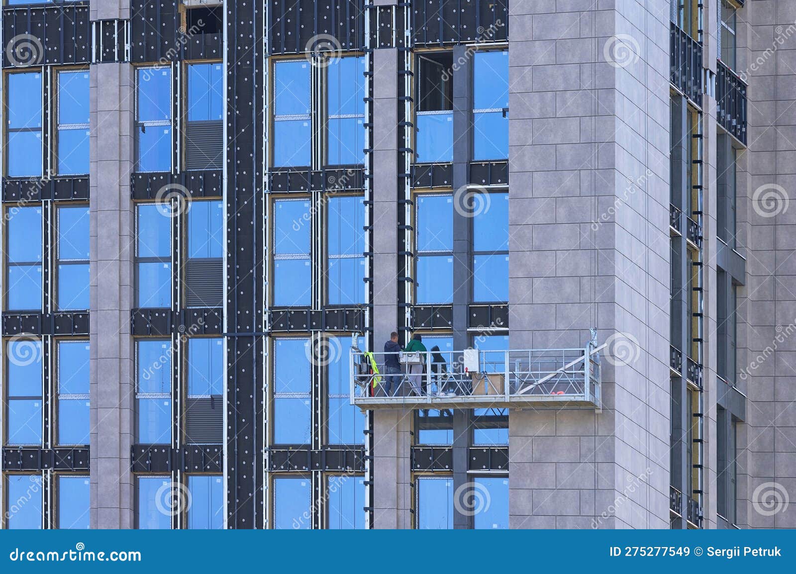 Builders on a Suspended Cradle Mount Decorative Panels on the Facade of ...