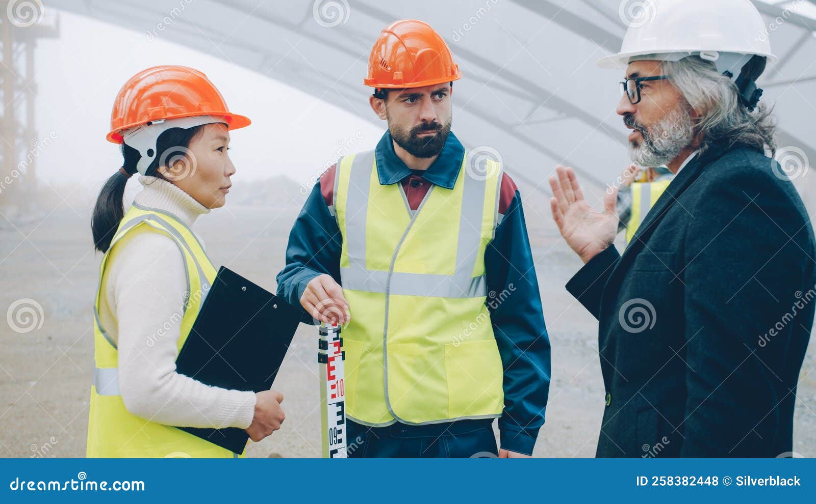 Builders Talking at Construction Site while Architect Coming Discussing ...